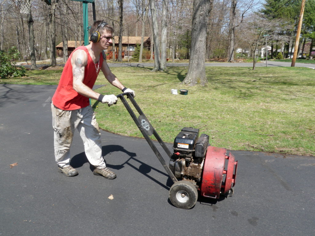 Blowing Off Debris from Driveway - Durable Sealcoat